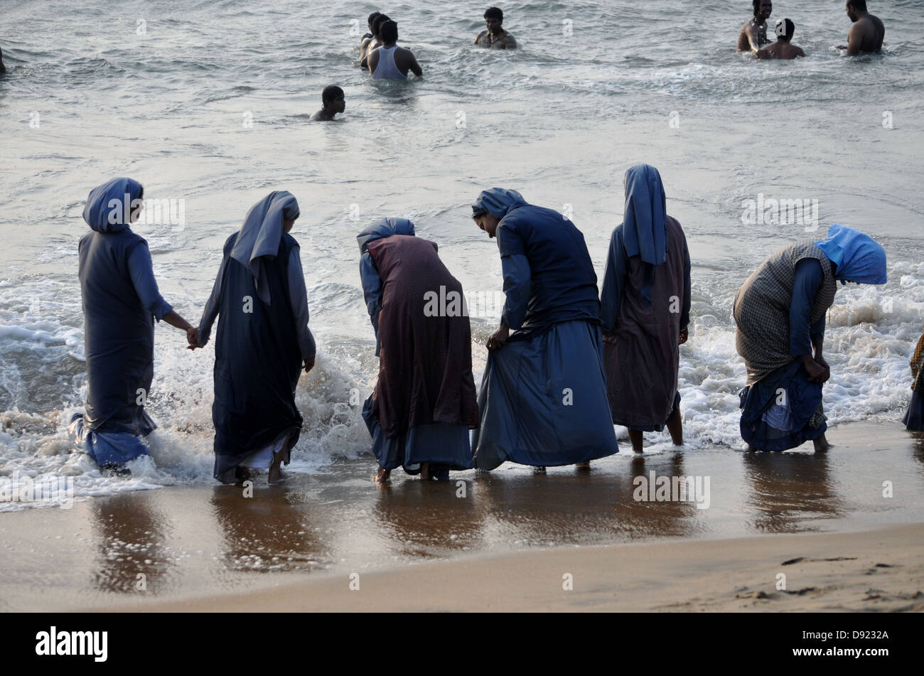 Nuns wade into the waves Stock Photo - Alamy