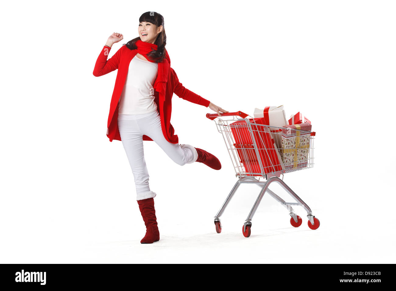 Young woman pulling shopping cart Stock Photo - Alamy