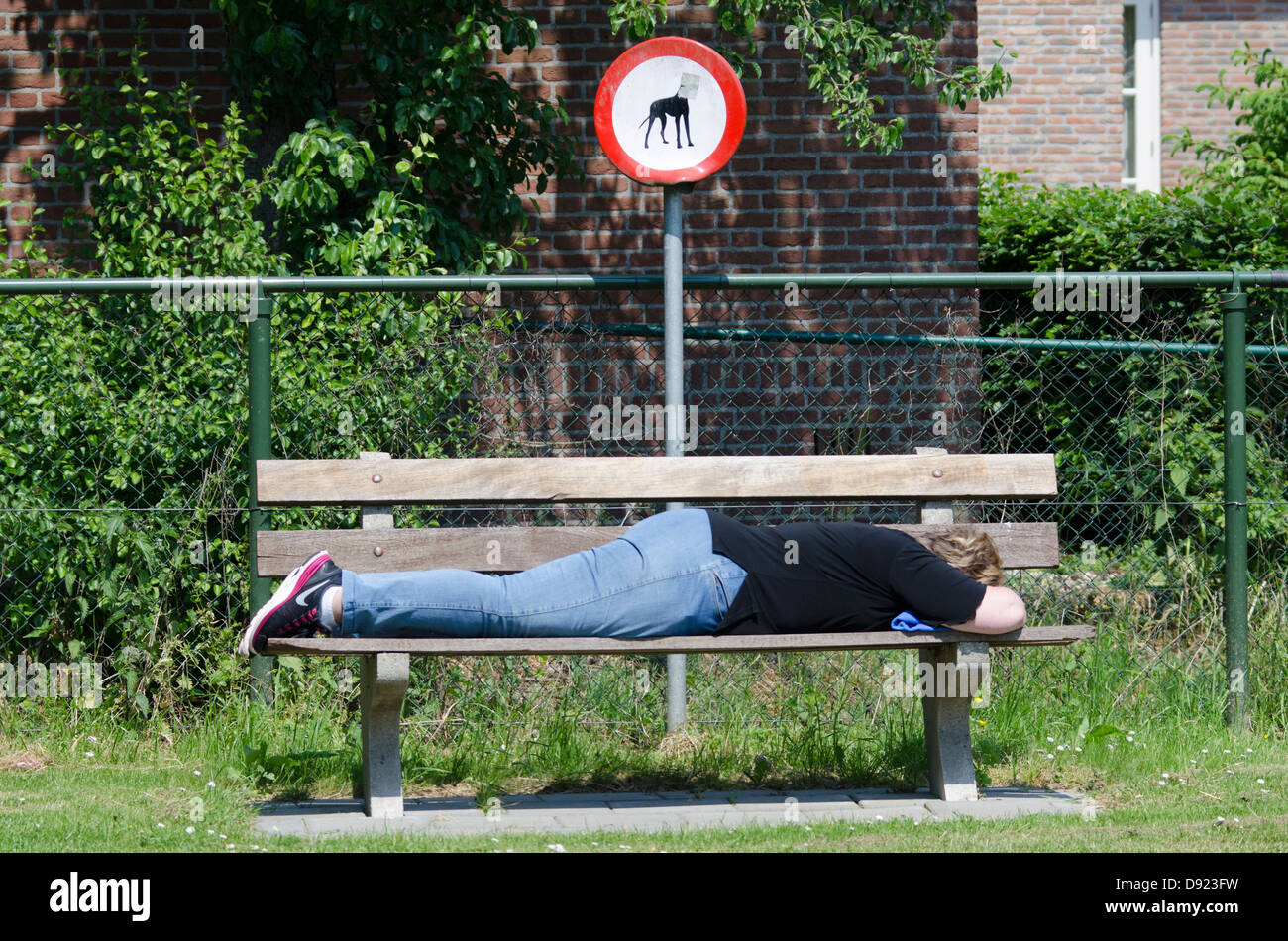 Woman resting on bench Stock Photo - Alamy
