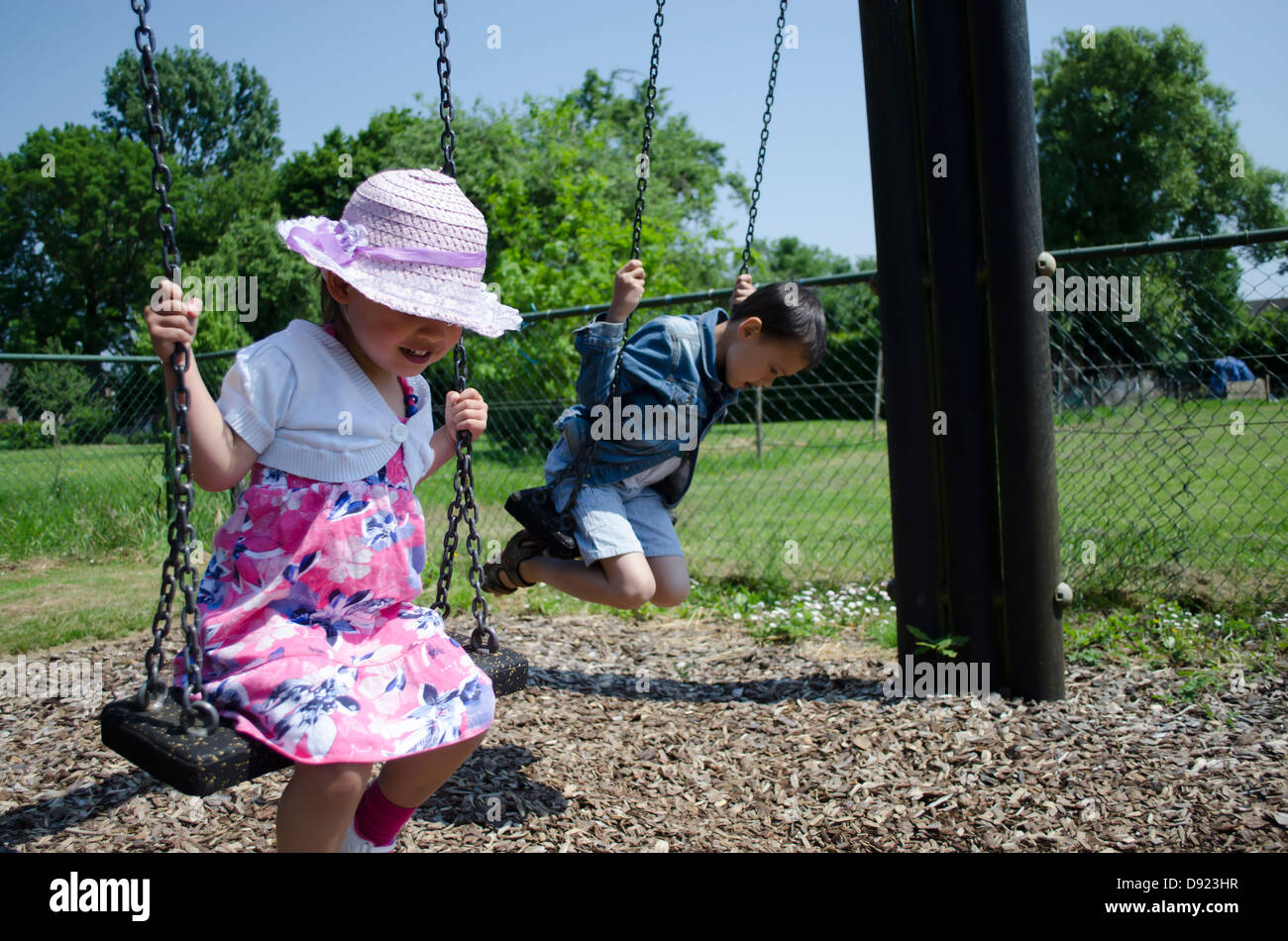 Kids on swing hi-res stock photography and images - Alamy