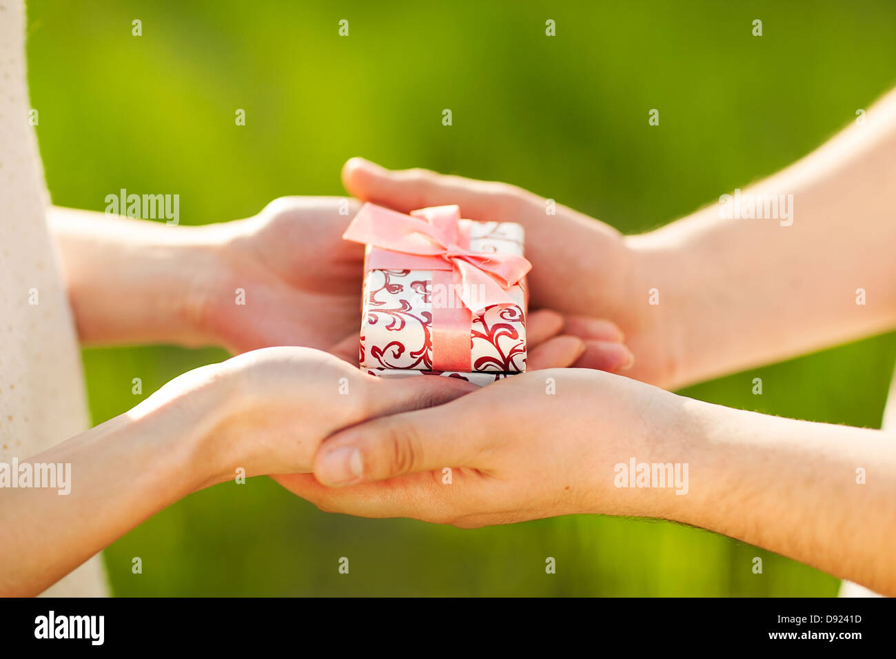 girl holding a gift in hand Stock Photo - Alamy