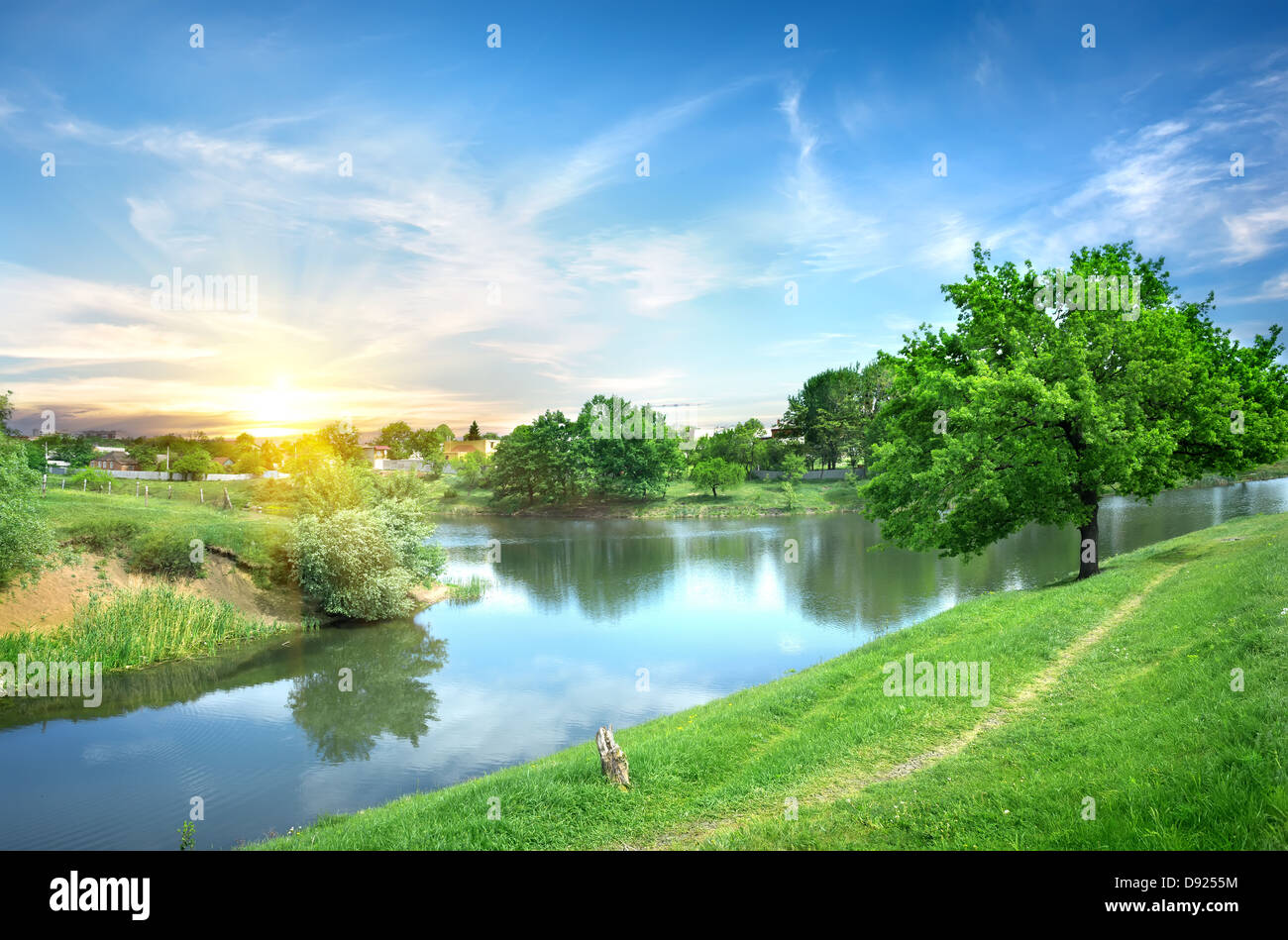 Spring landscape with the river and the sun Stock Photo - Alamy