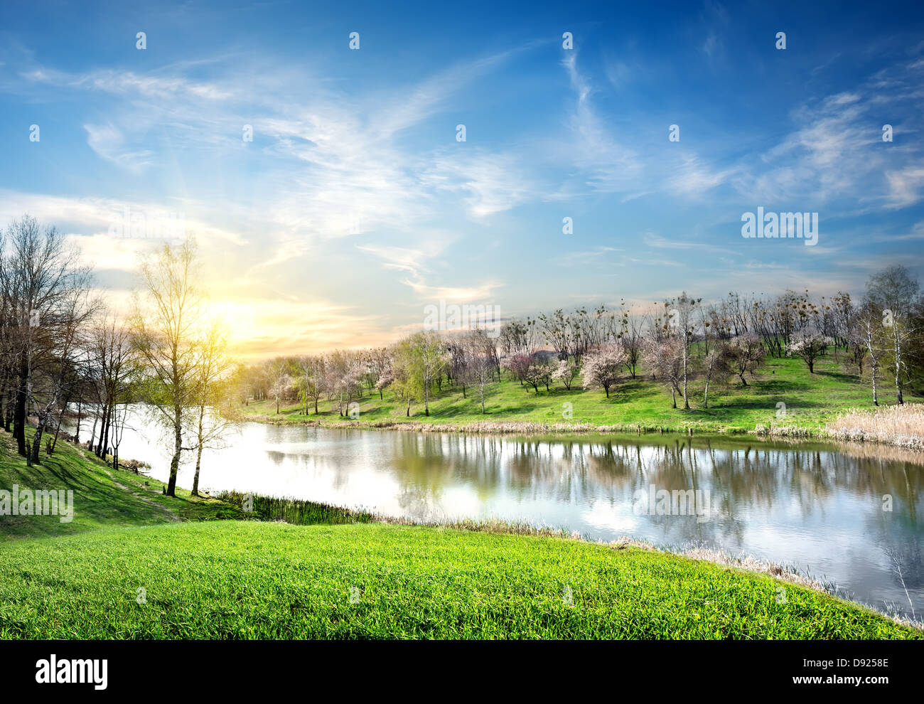 Spring landscape with the river and the sun Stock Photo - Alamy
