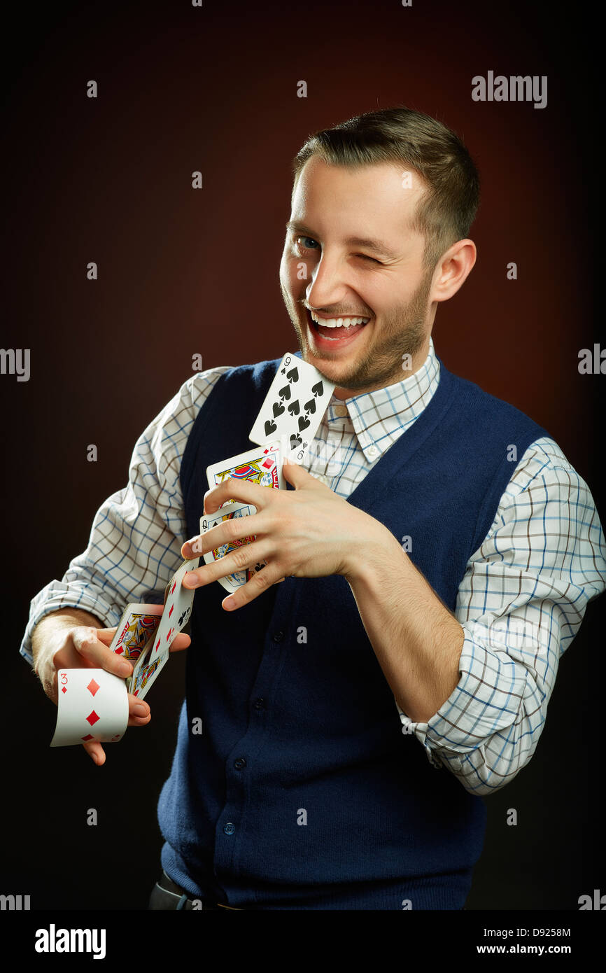 Magician holding playing cards hi-res stock photography and images - Alamy