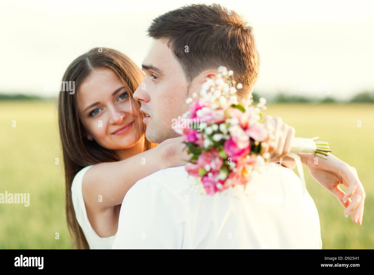 Just married couple hugging and smiling Stock Photo - Alamy
