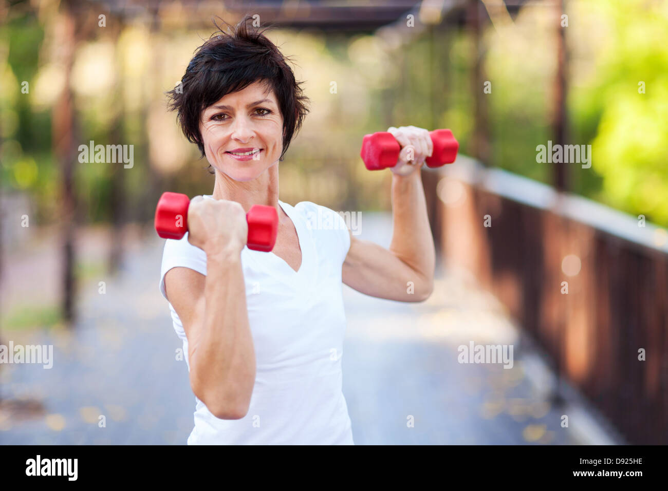 active middle aged woman workout with dumbbells Stock Photo - Alamy