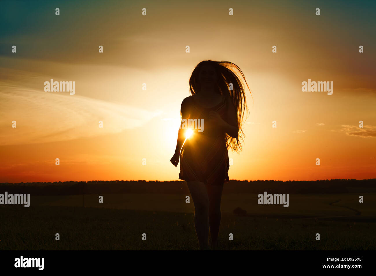 Girl runs at sunset silhouette Stock Photo - Alamy