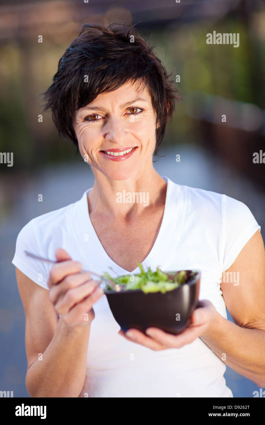healthy middle aged woman eating green salad Stock Photo - Alamy