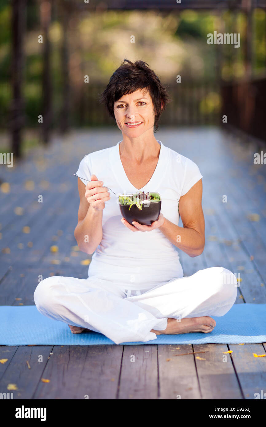 healthy middle aged woman eating salad outdoors Stock Photo - Alamy