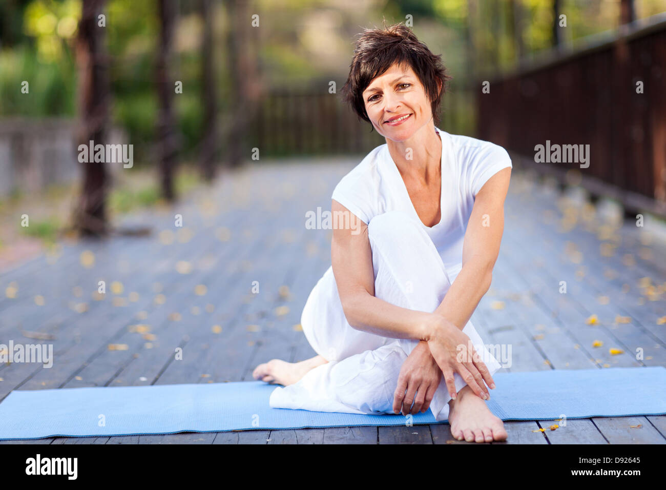 fit middle aged woman relaxing after workout Stock Photo - Alamy