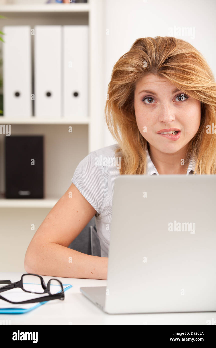 Closeup smiling office worker in front of laptop computer sitting in ...