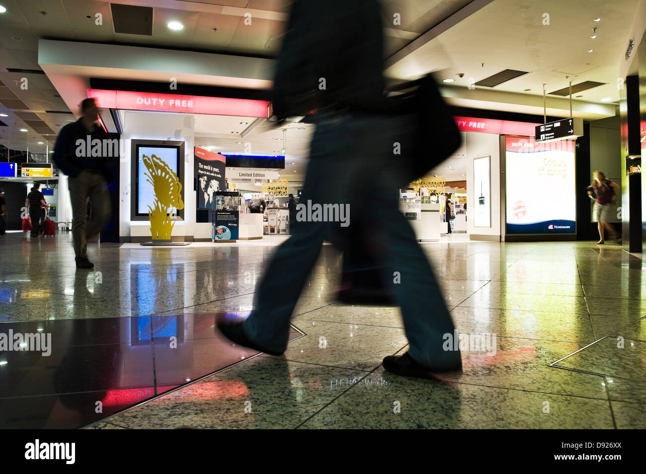 blurred motion of human figures against a background of neon signs ...