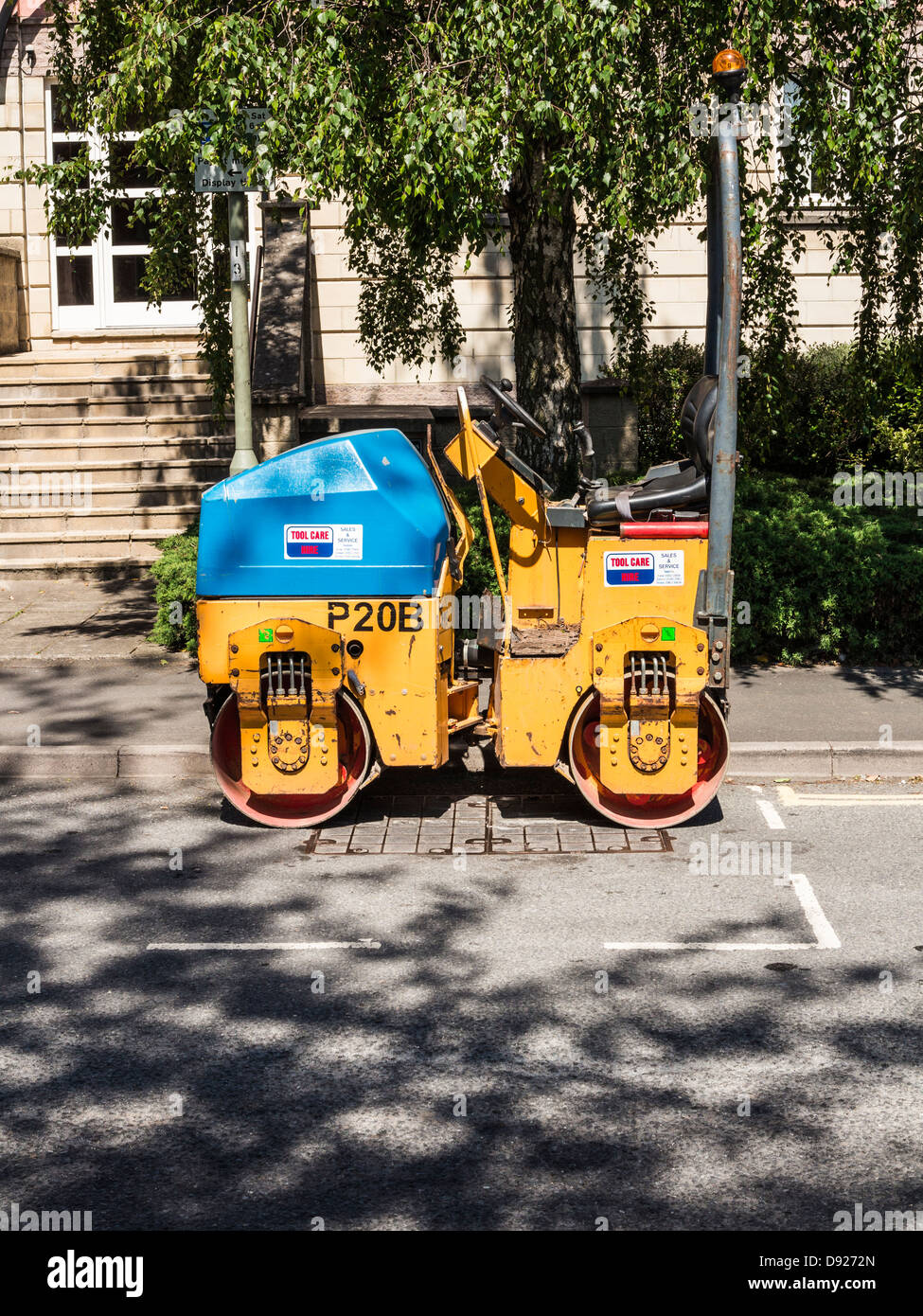 Road roller parked in parking bay on a road, Exeter, Devon, England ...