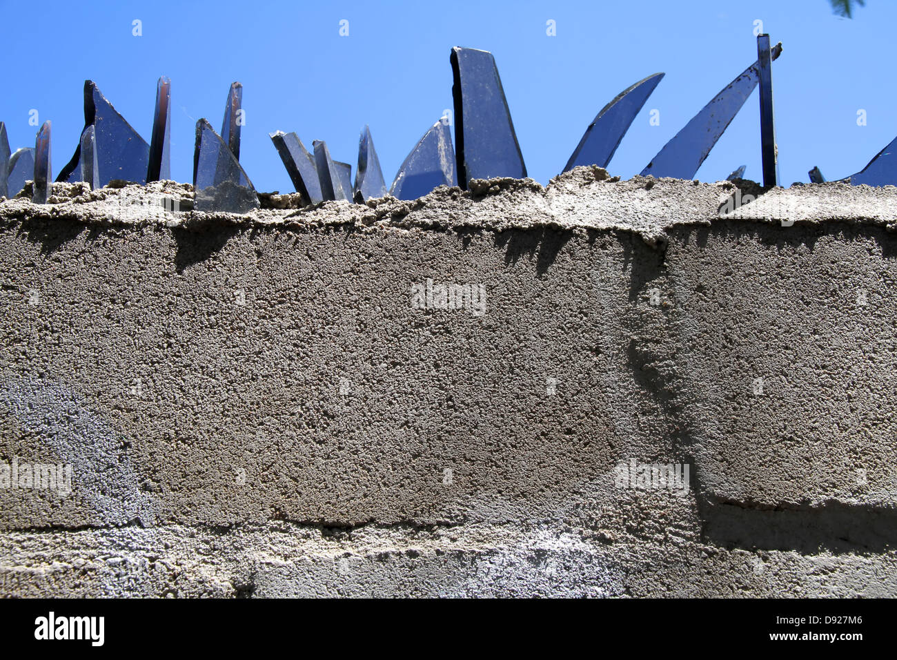 A wall with glass pieces for protection of intruders Stock Photo - Alamy