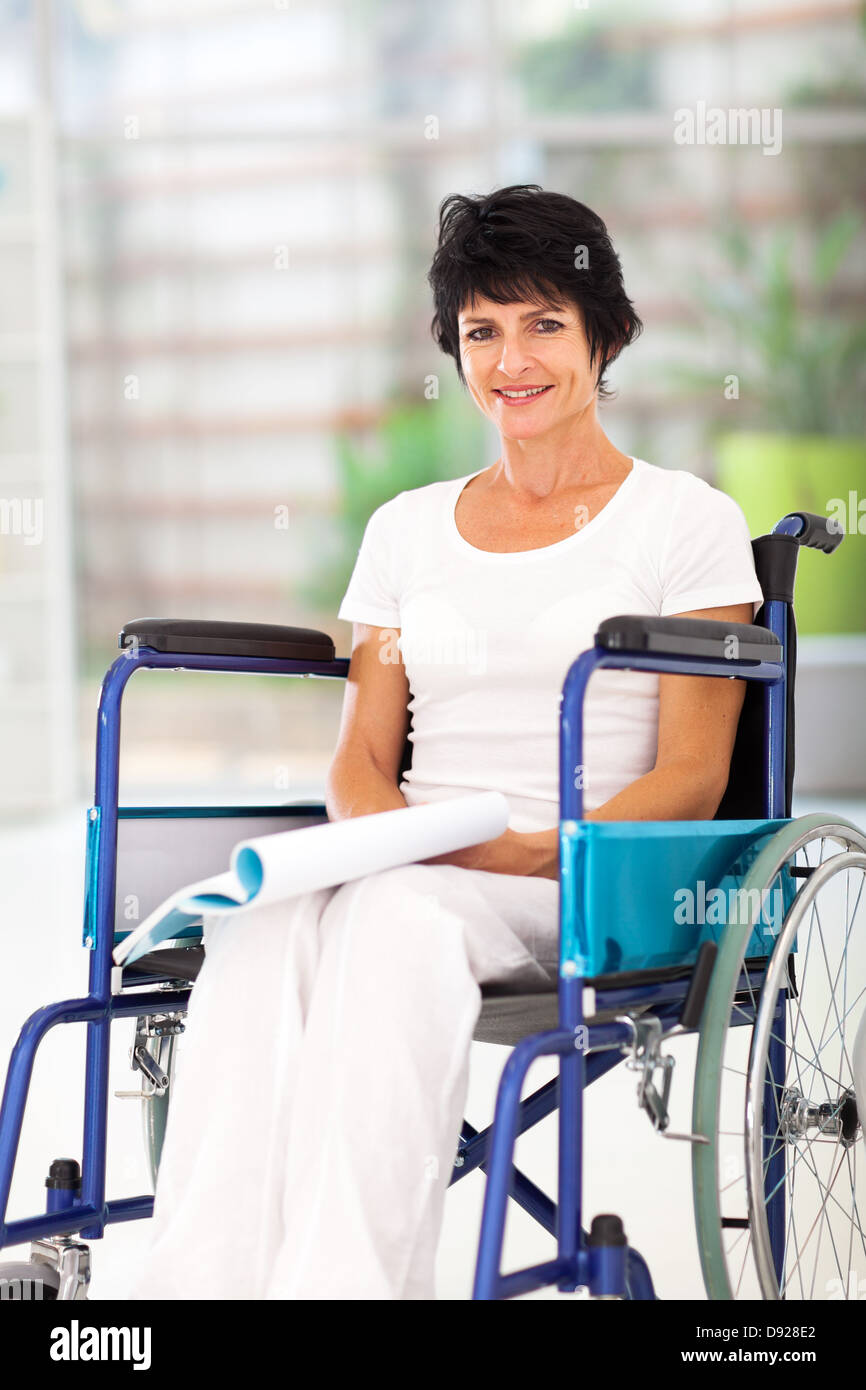 handicapped middle aged woman reading book on wheelchair Stock Photo ...