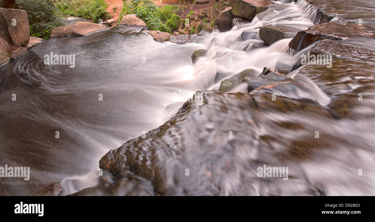 Flowing stream over water fall Stock Photo - Alamy