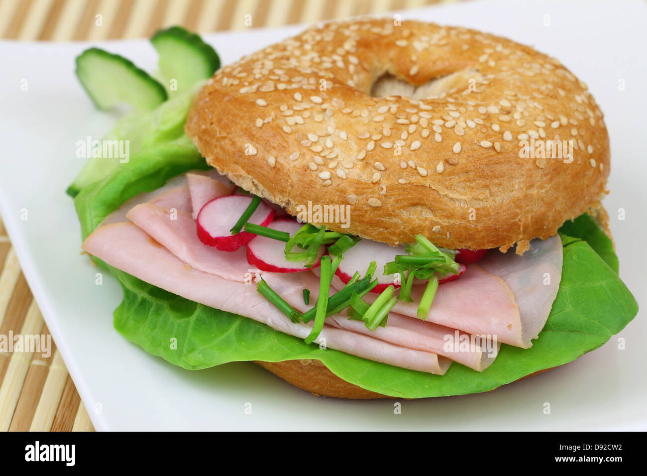 Bagel with ham, lettuce, cucumber and radish, close up Stock Photo - Alamy