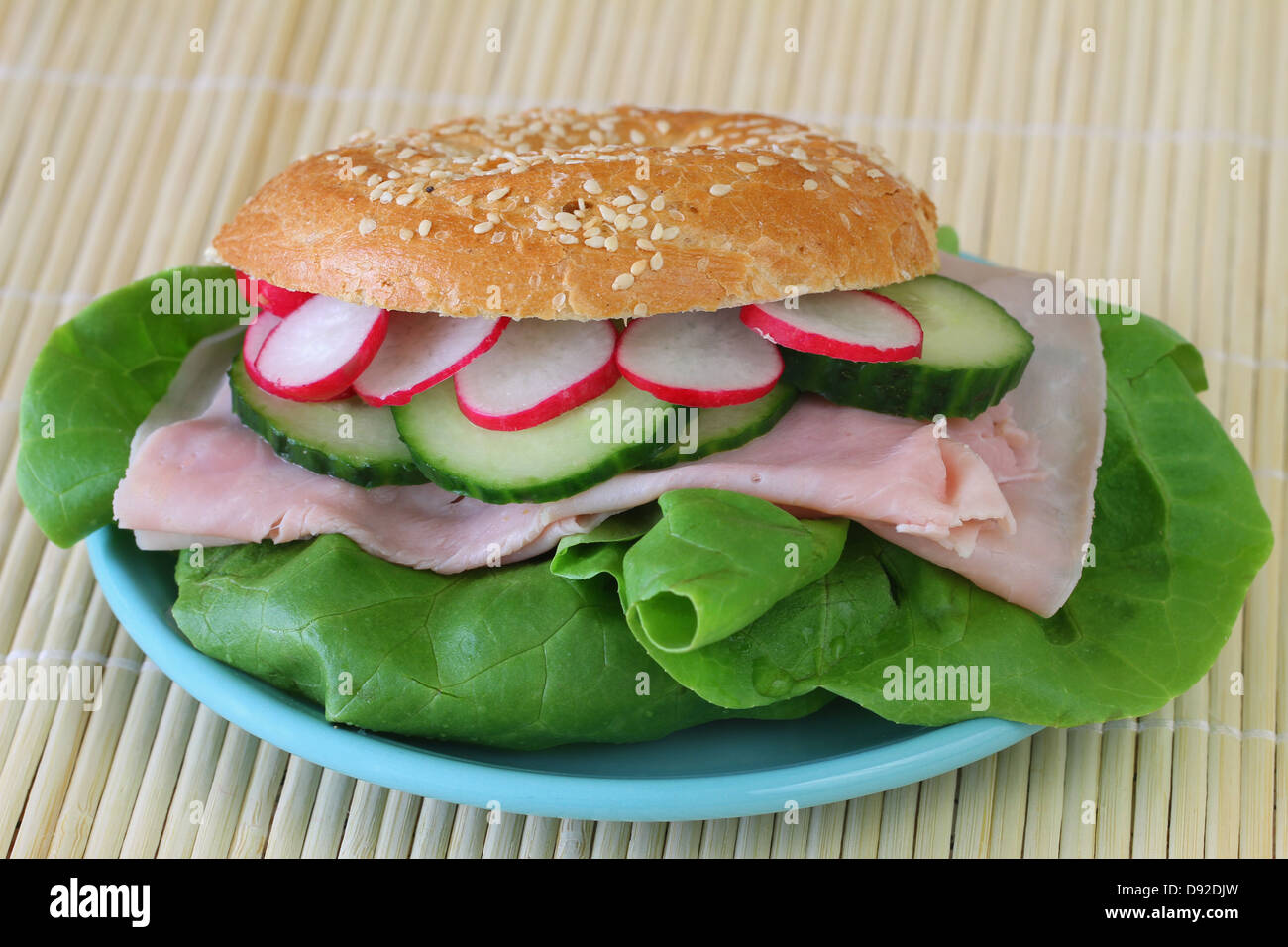 Bagel with ham, lettuce, cucumber and radish, close up Stock Photo - Alamy