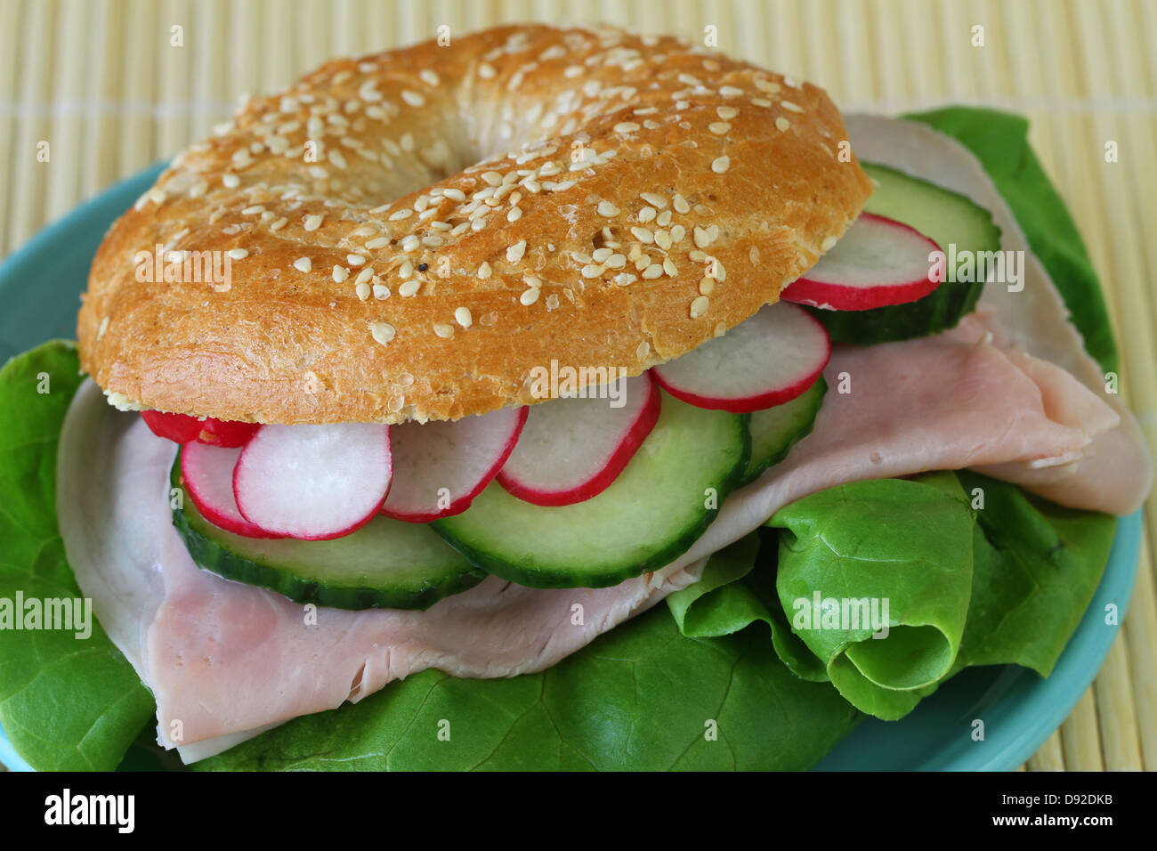 Bagel with ham, lettuce, cucumber and radish, close up Stock Photo - Alamy