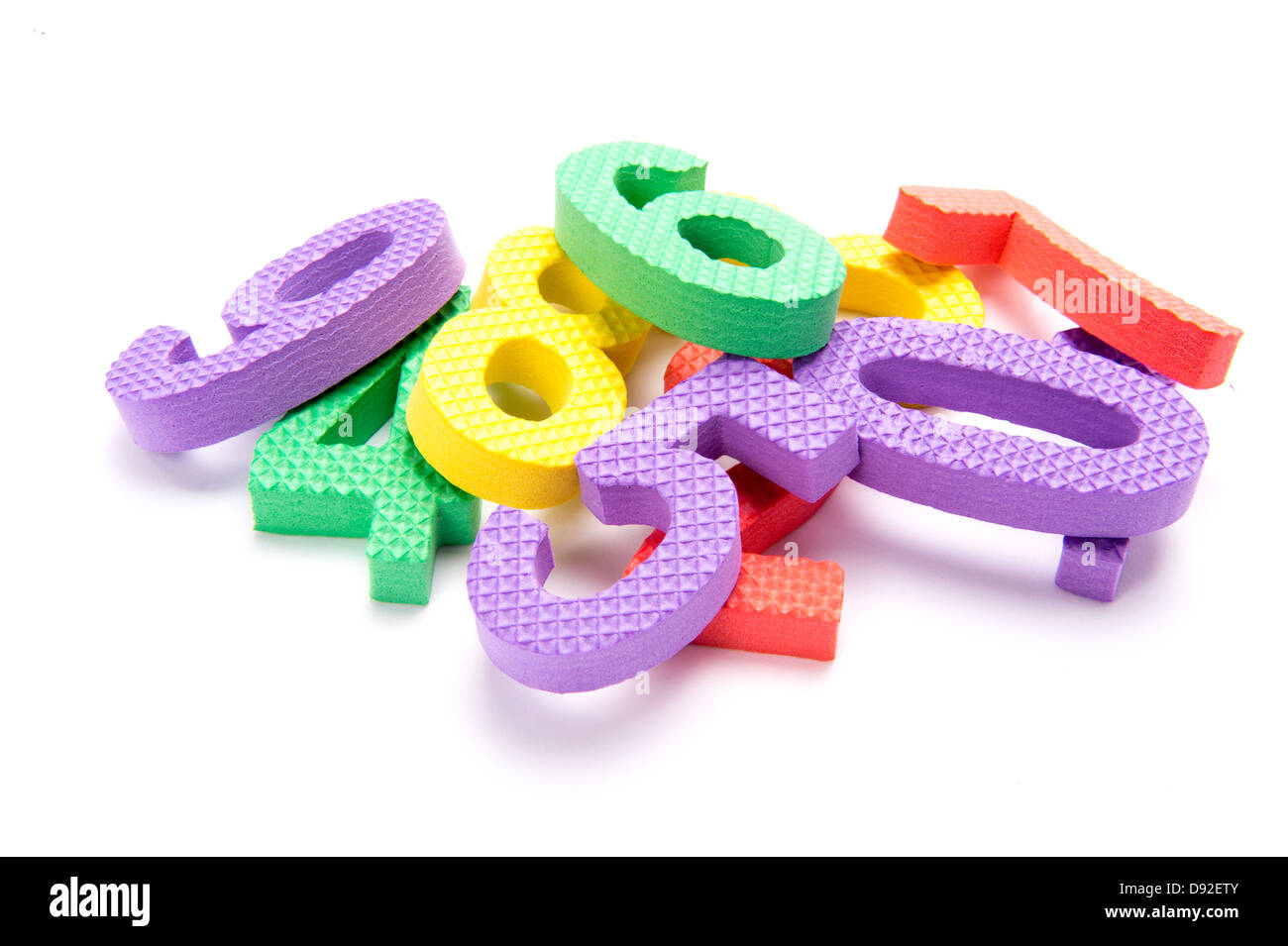 A pile of colorful numbers in children's foam on white background Stock ...