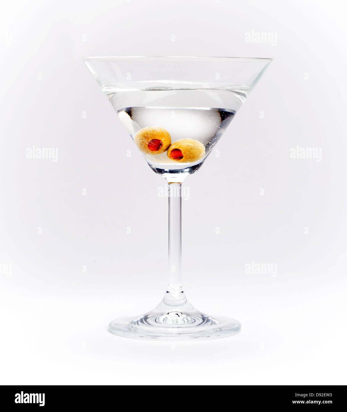 Closeup of Martini cocktail with olives on white - grey background ...
