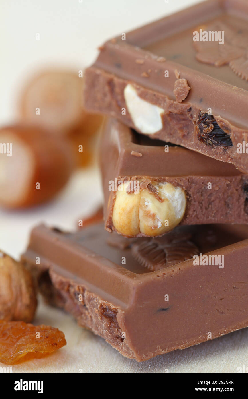 Milk chocolate with nuts and raisins, close up Stock Photo - Alamy