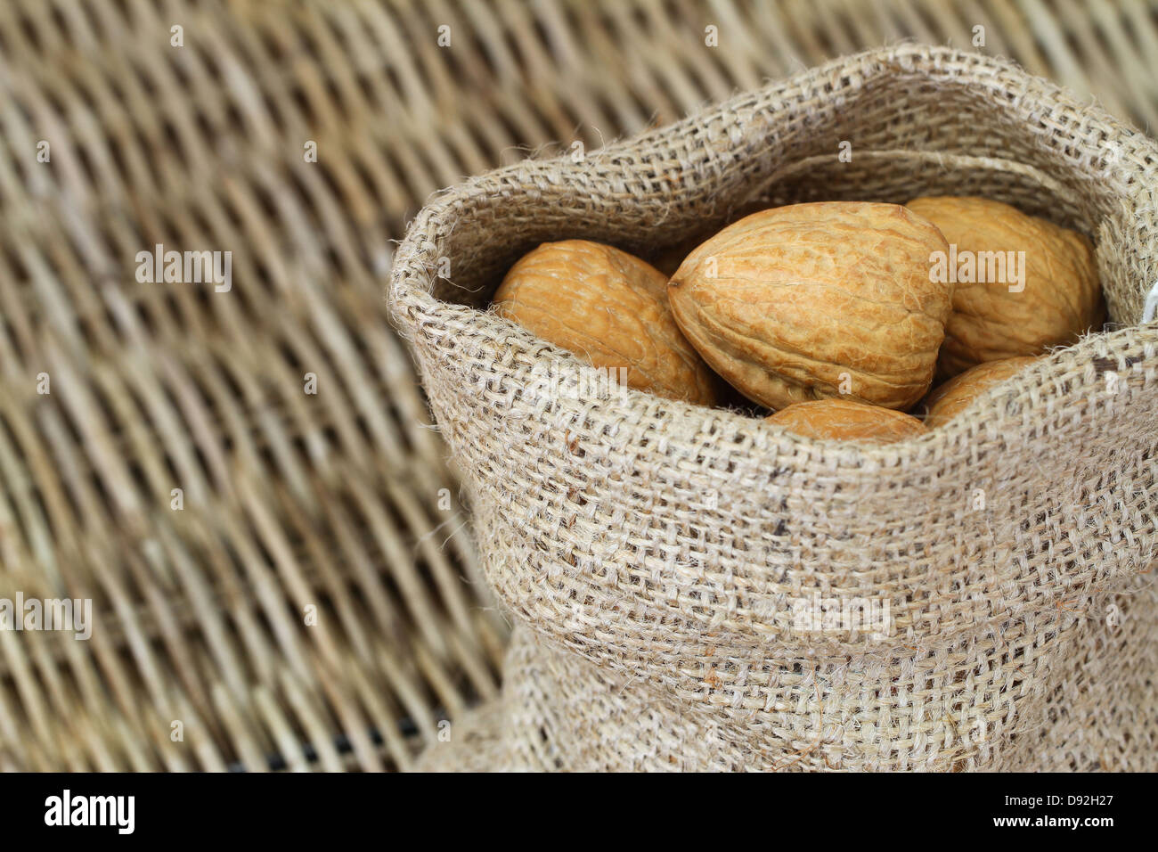Whole walnuts in jute bag on wicker background with copy space Stock ...