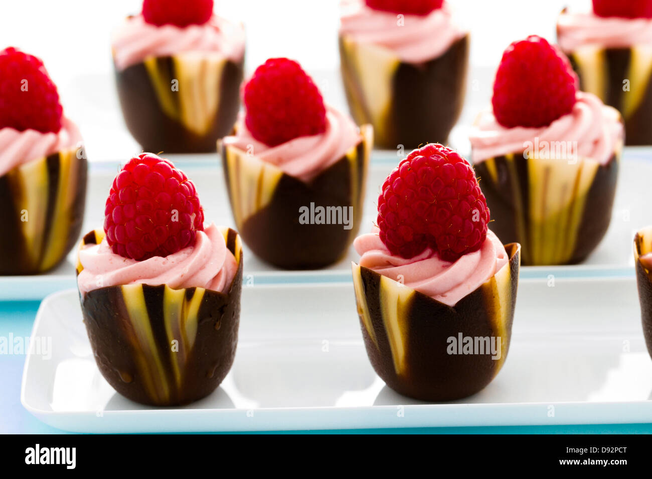 Small chocolate reaspherry tulip cups at dessert bar Stock Photo - Alamy