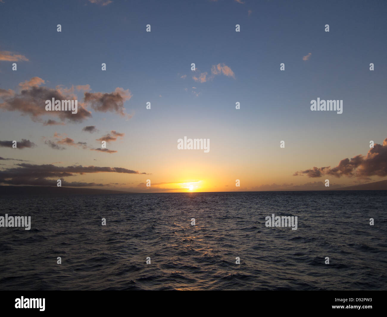 Maui Sunset over the ocean with vast blue skies Stock Photo - Alamy