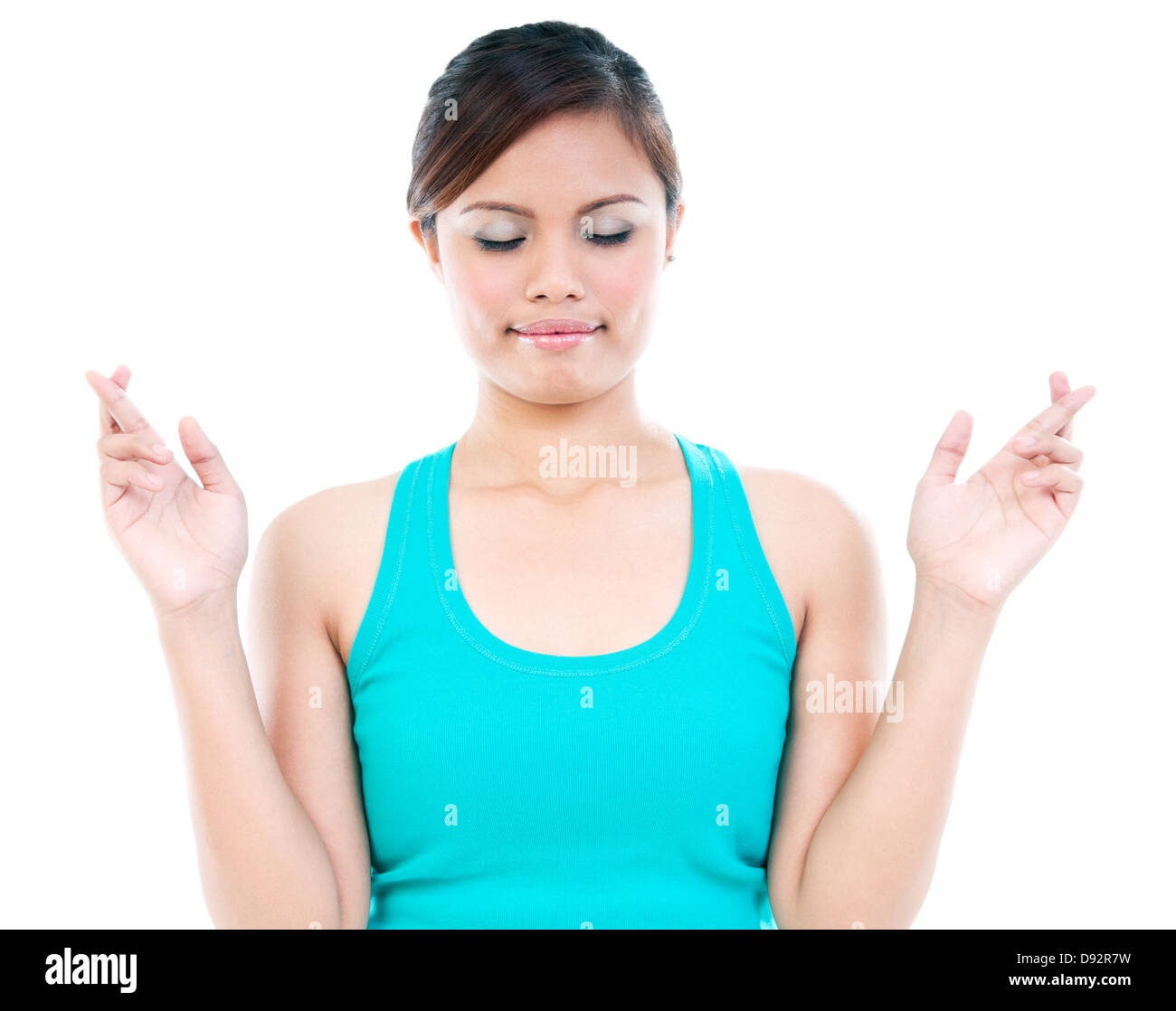 Young woman keeping her fingers crossed, portrait Stock Photo - Alamy