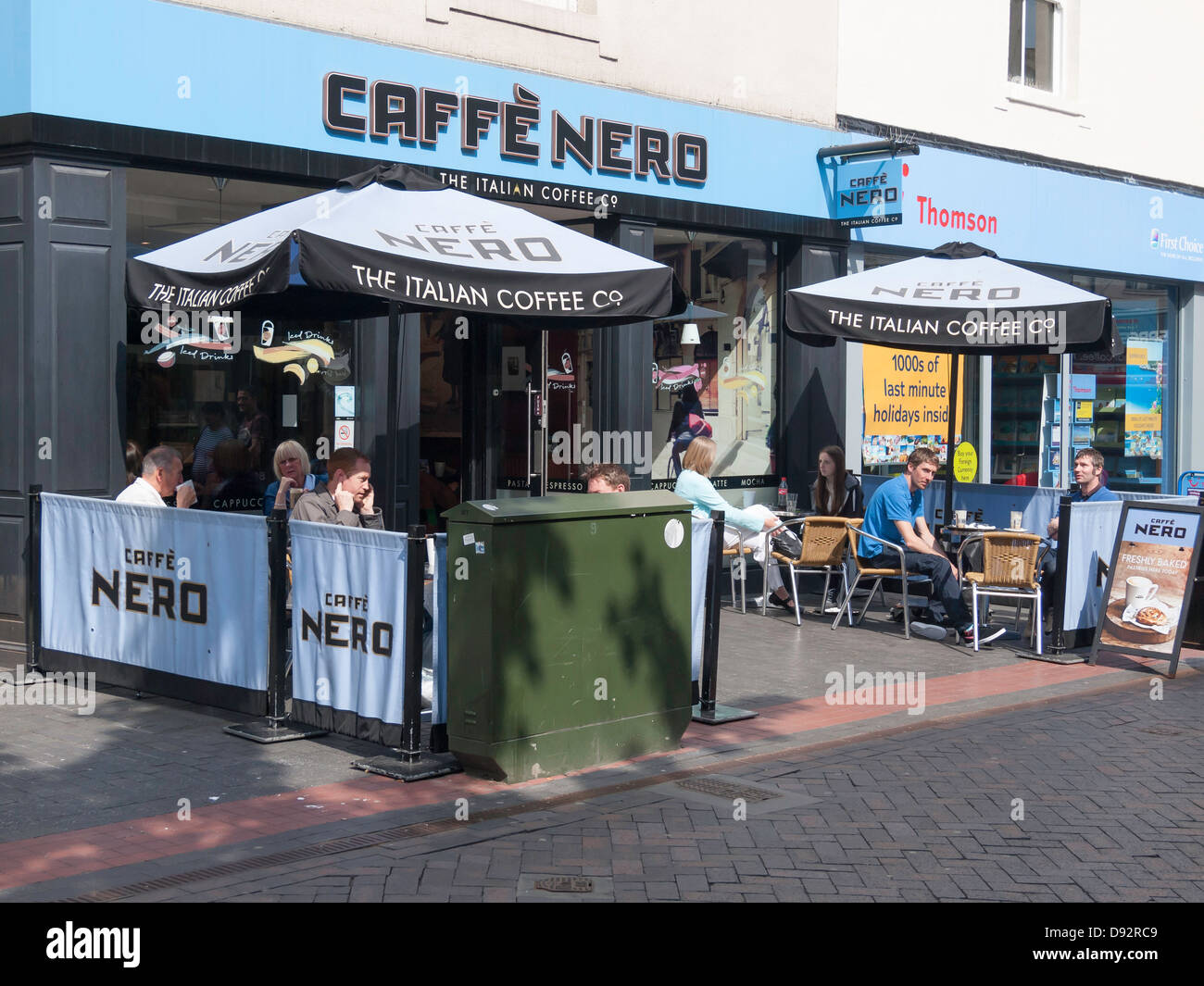 People having coffee outside a branch of Caffe Nero an Italian coffee ...