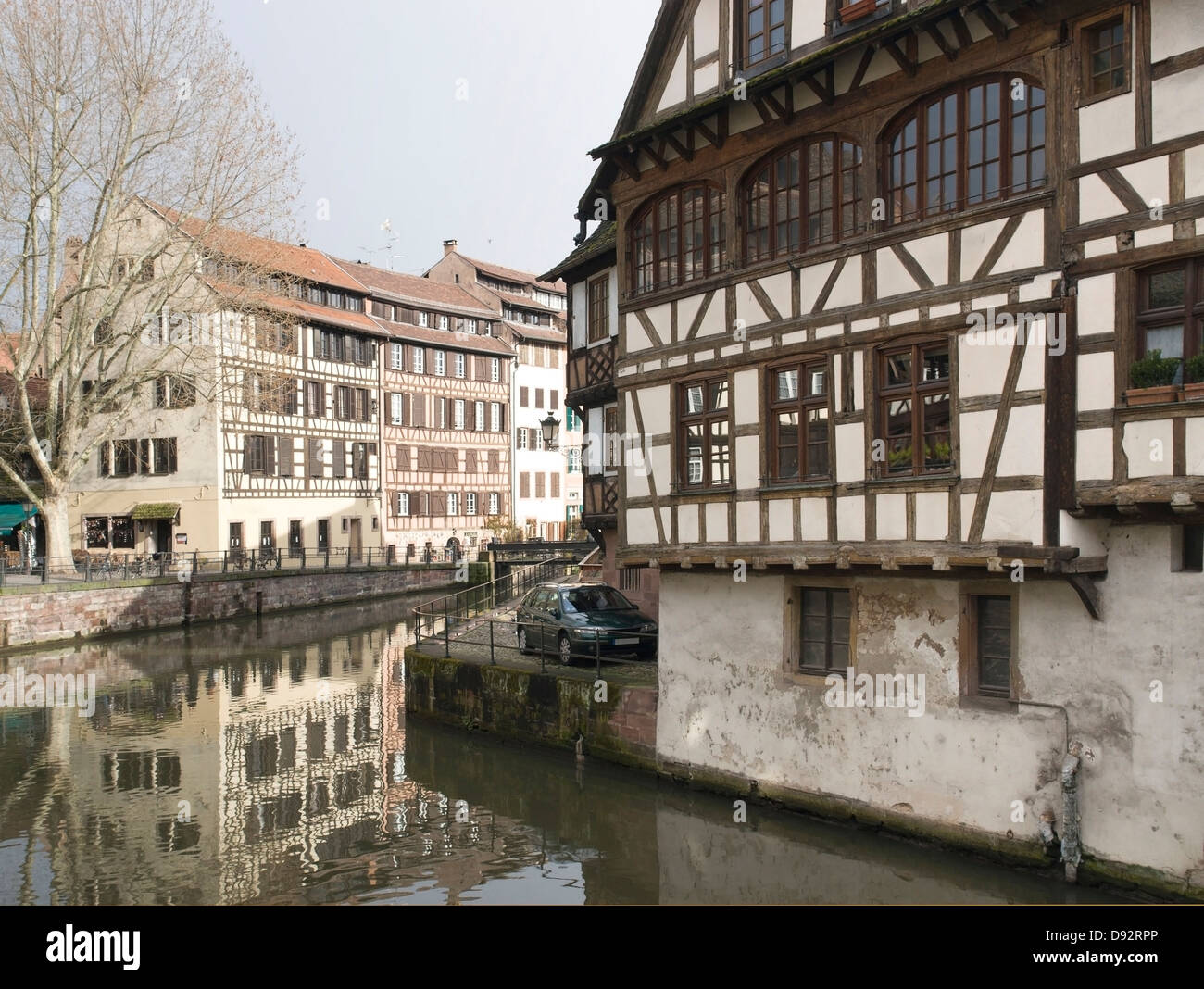 idyllic scenery in Strasbourg with half timbered houses near a canal ...