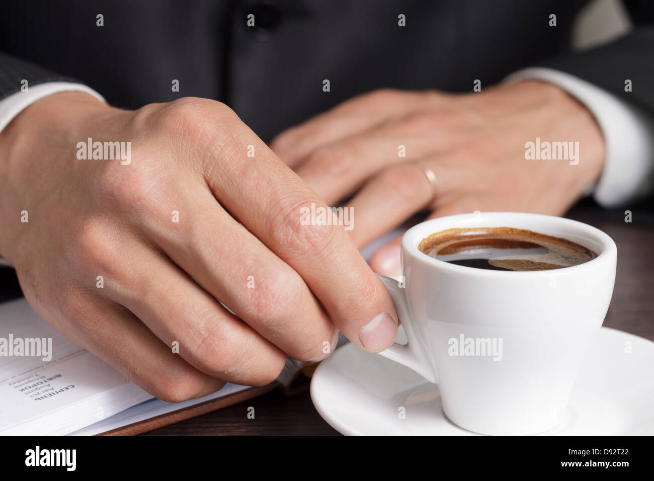 Businessman makes coffee break after work with diary Stock Photo - Alamy