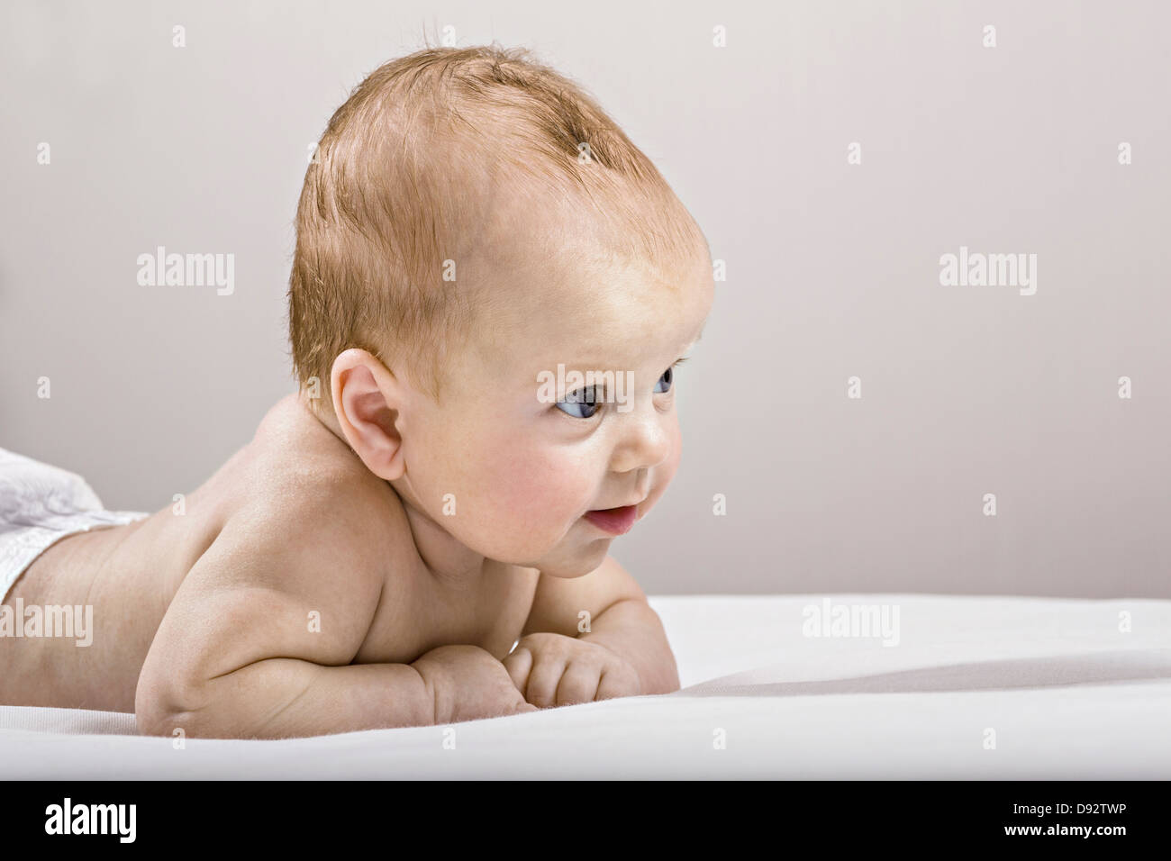 Baby lying under blanket hi-res stock photography and images - Alamy