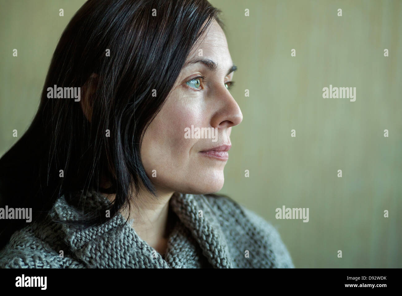 Pensive woman looking into distance Stock Photo - Alamy