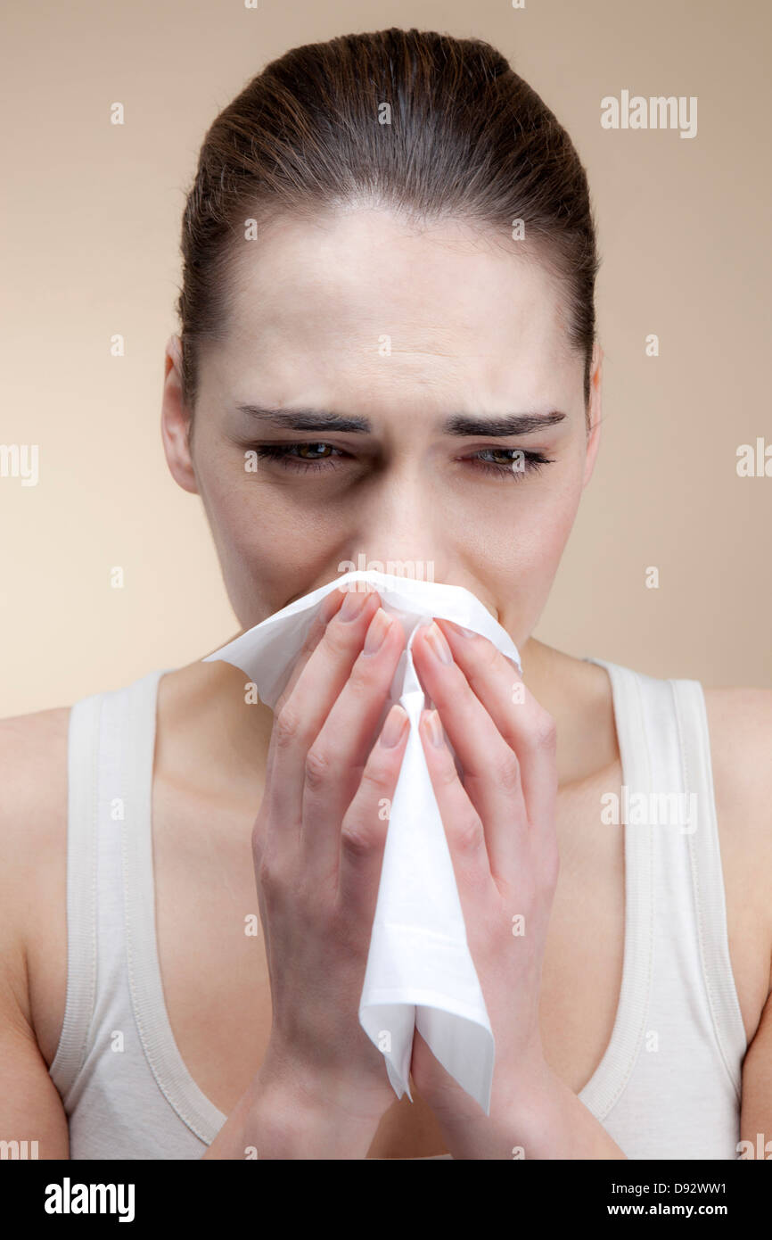 A sad woman crying and blowing her nose Stock Photo - Alamy