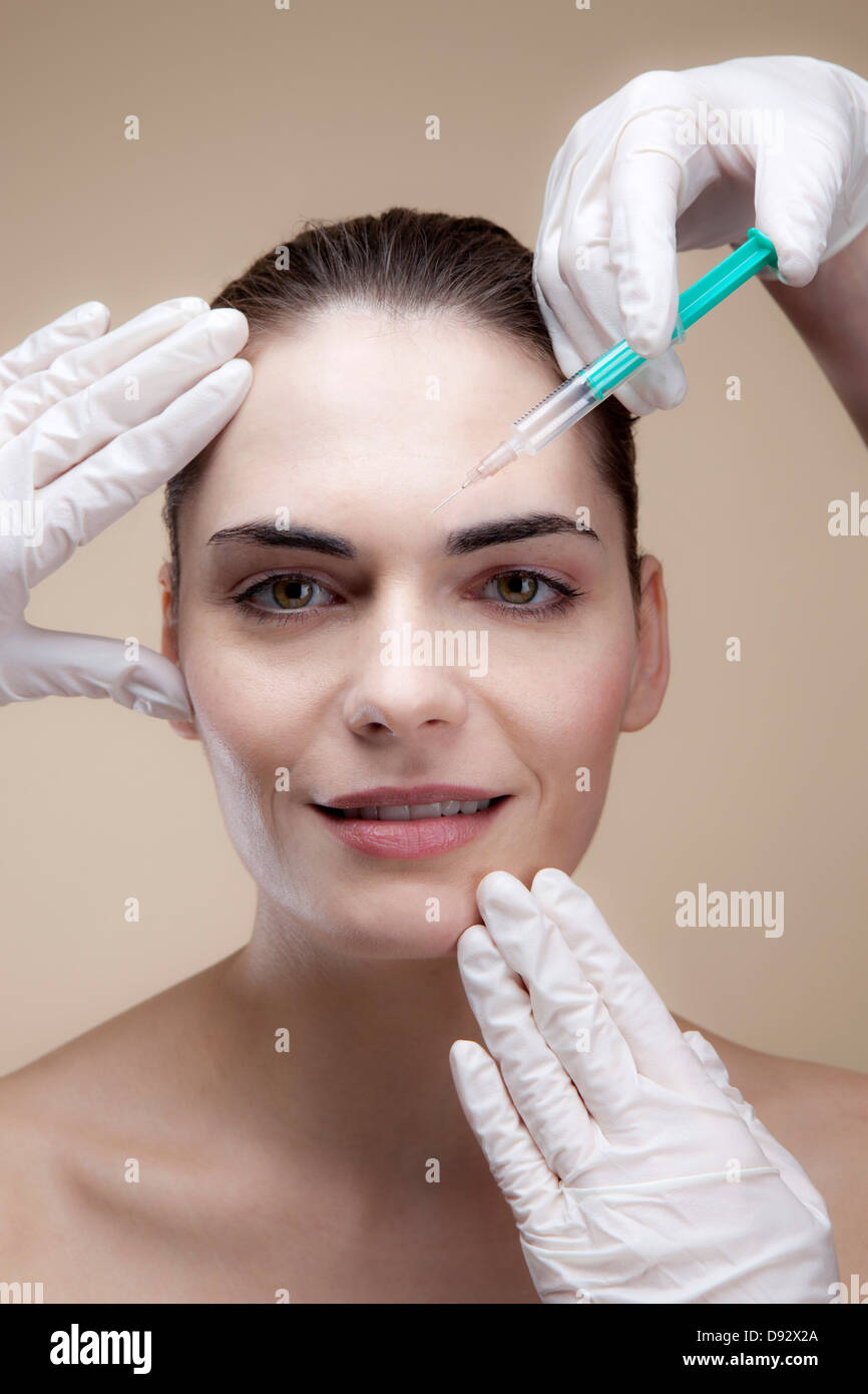 A smiling young woman receiving Botox injections Stock Photo - Alamy