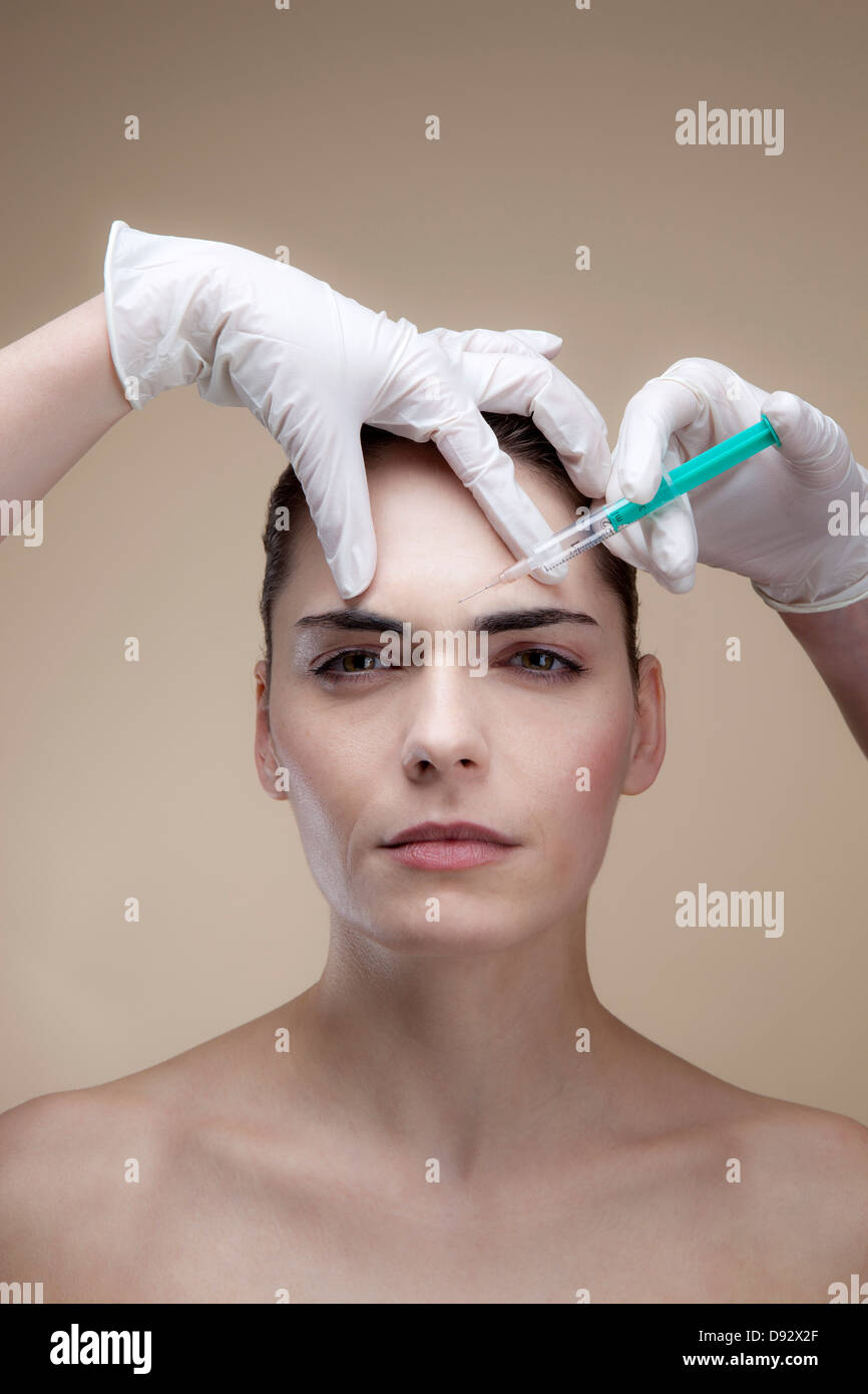 A serious young woman receiving Botox injections Stock Photo - Alamy