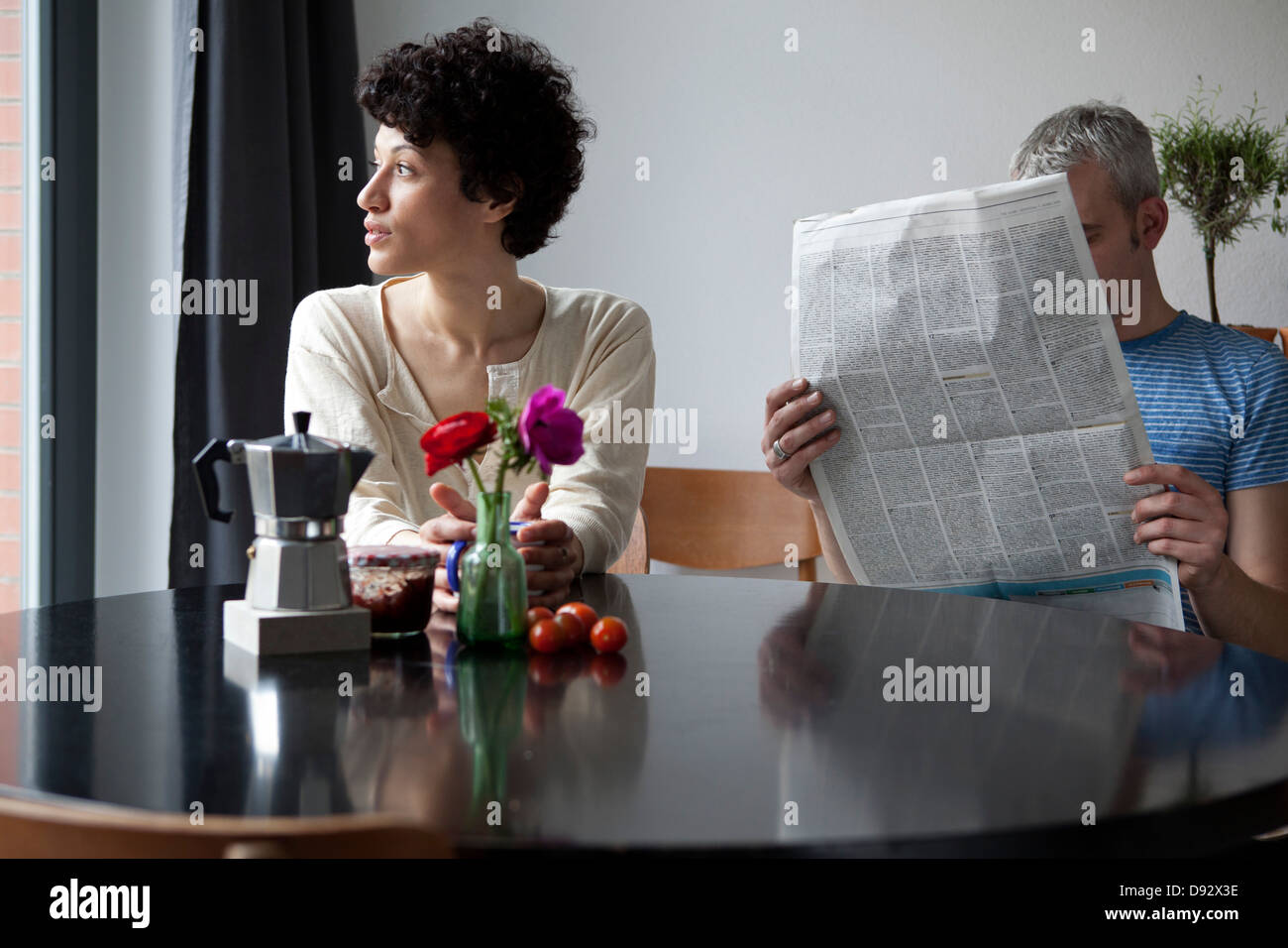 Hiding behind newspaper hi-res stock photography and images - Alamy