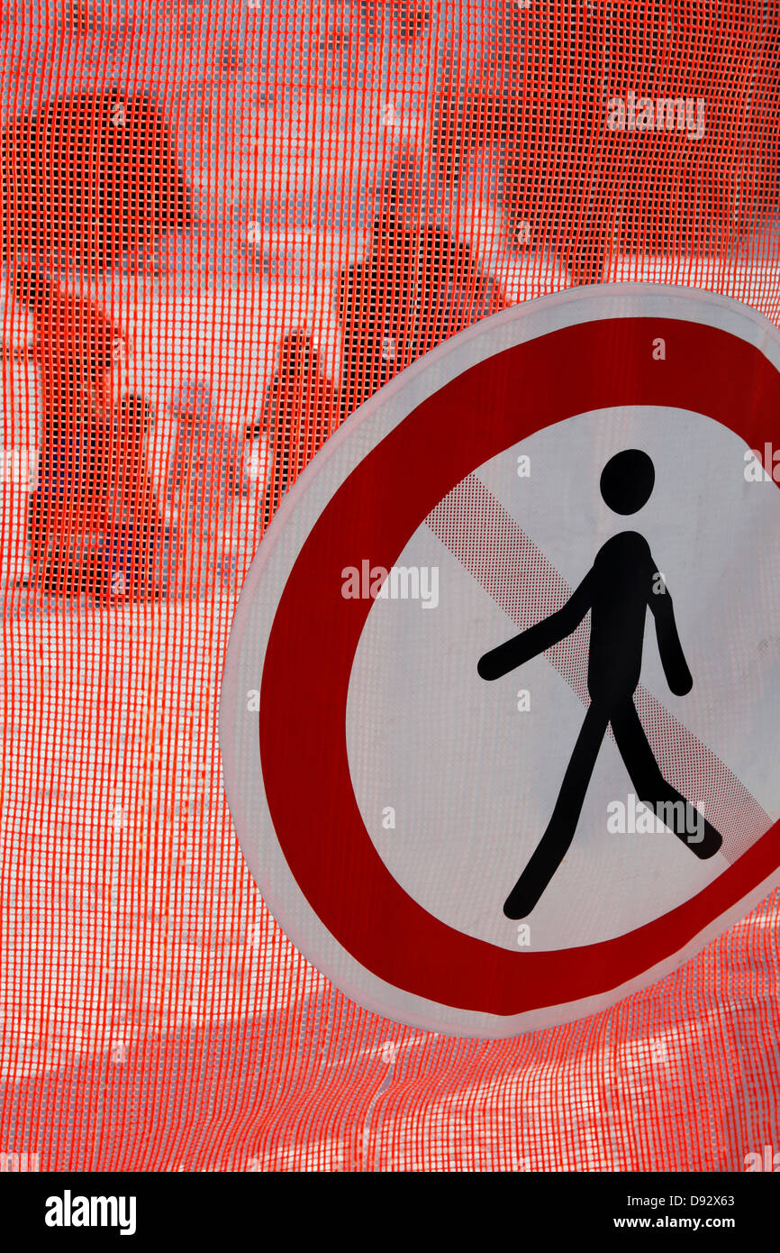 No pedestrian sign hanging on a mesh barrier Stock Photo - Alamy
