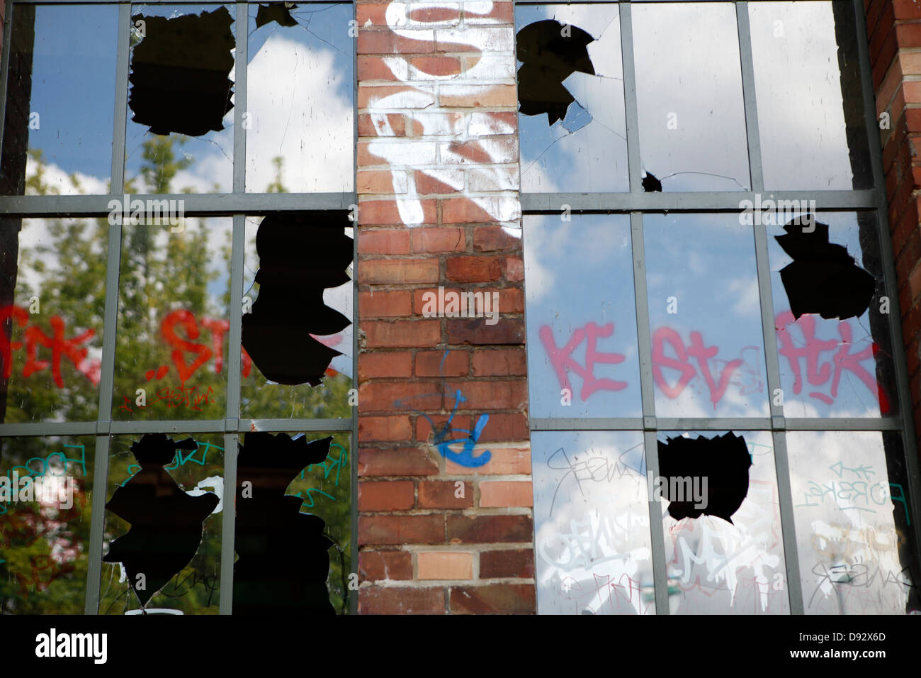 Detail of a building with broken windows and graffiti Stock Photo - Alamy
