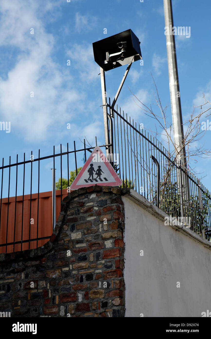 Low angle view of a video surveillance camera attached to a fence Stock ...