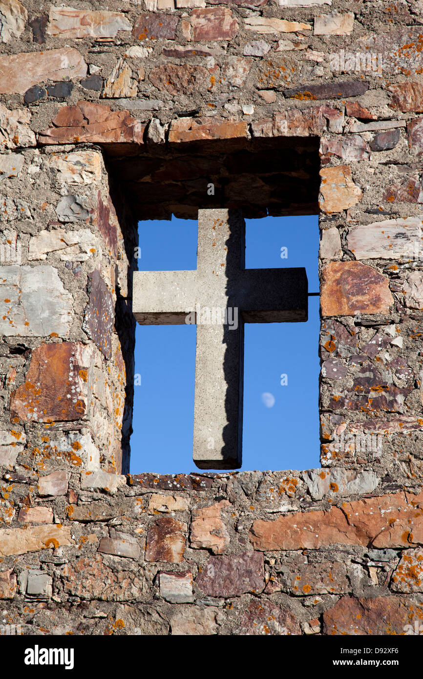 A cross in an open window of the stone wall of a church Stock Photo - Alamy