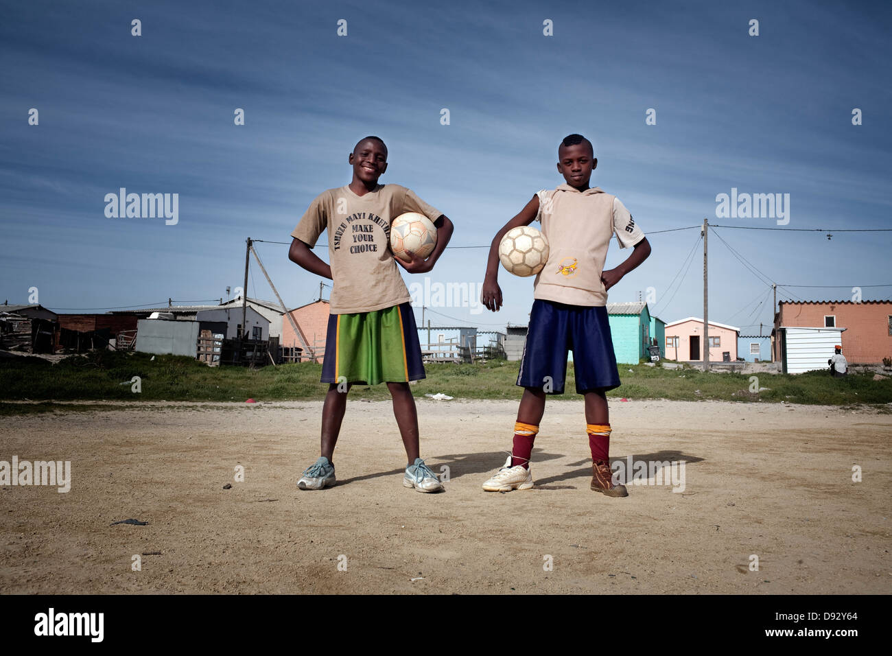 A portrait young african boys holding football They being coached ...