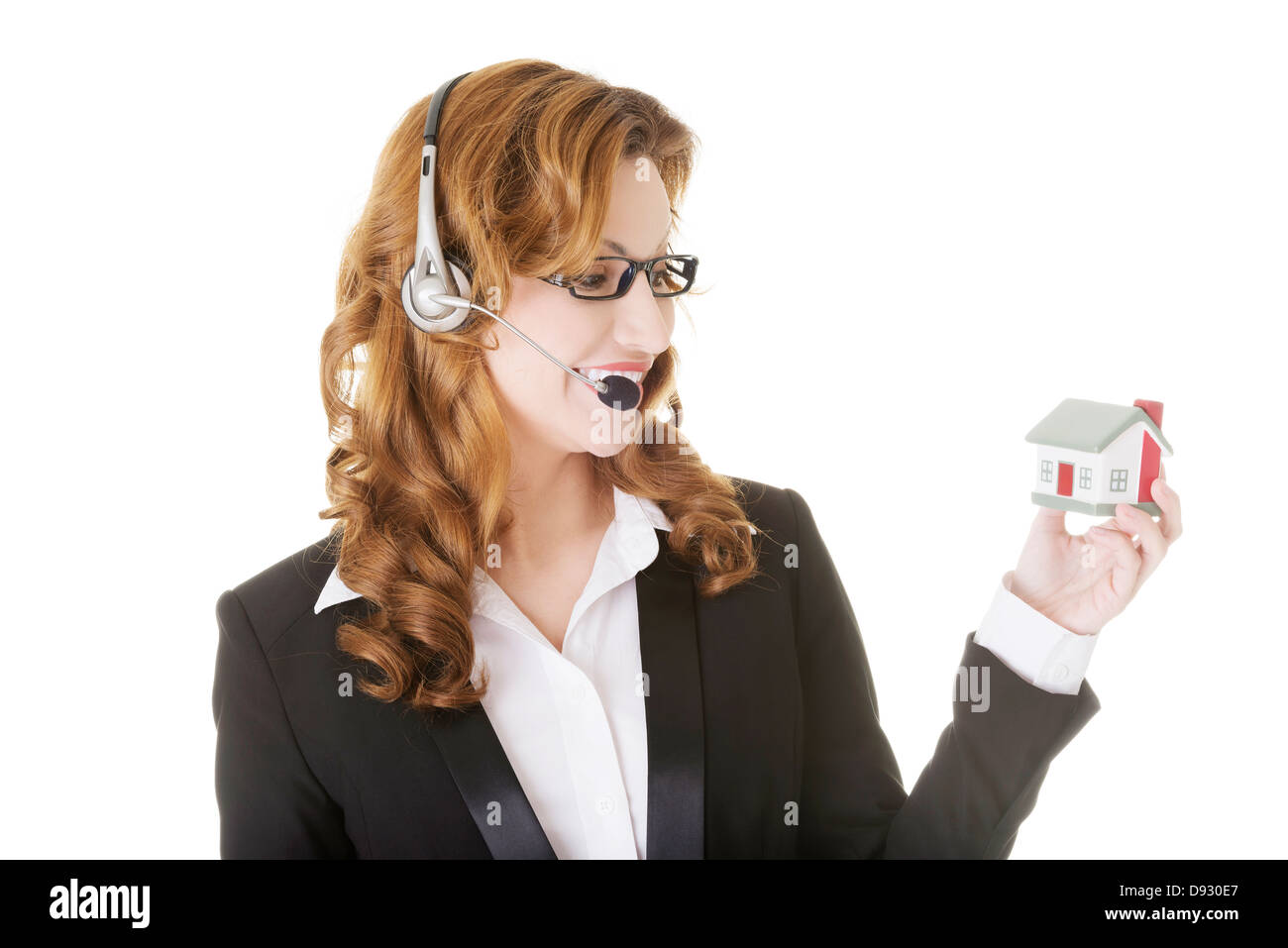 Attractive call center support woman with headset andhouse model in ...