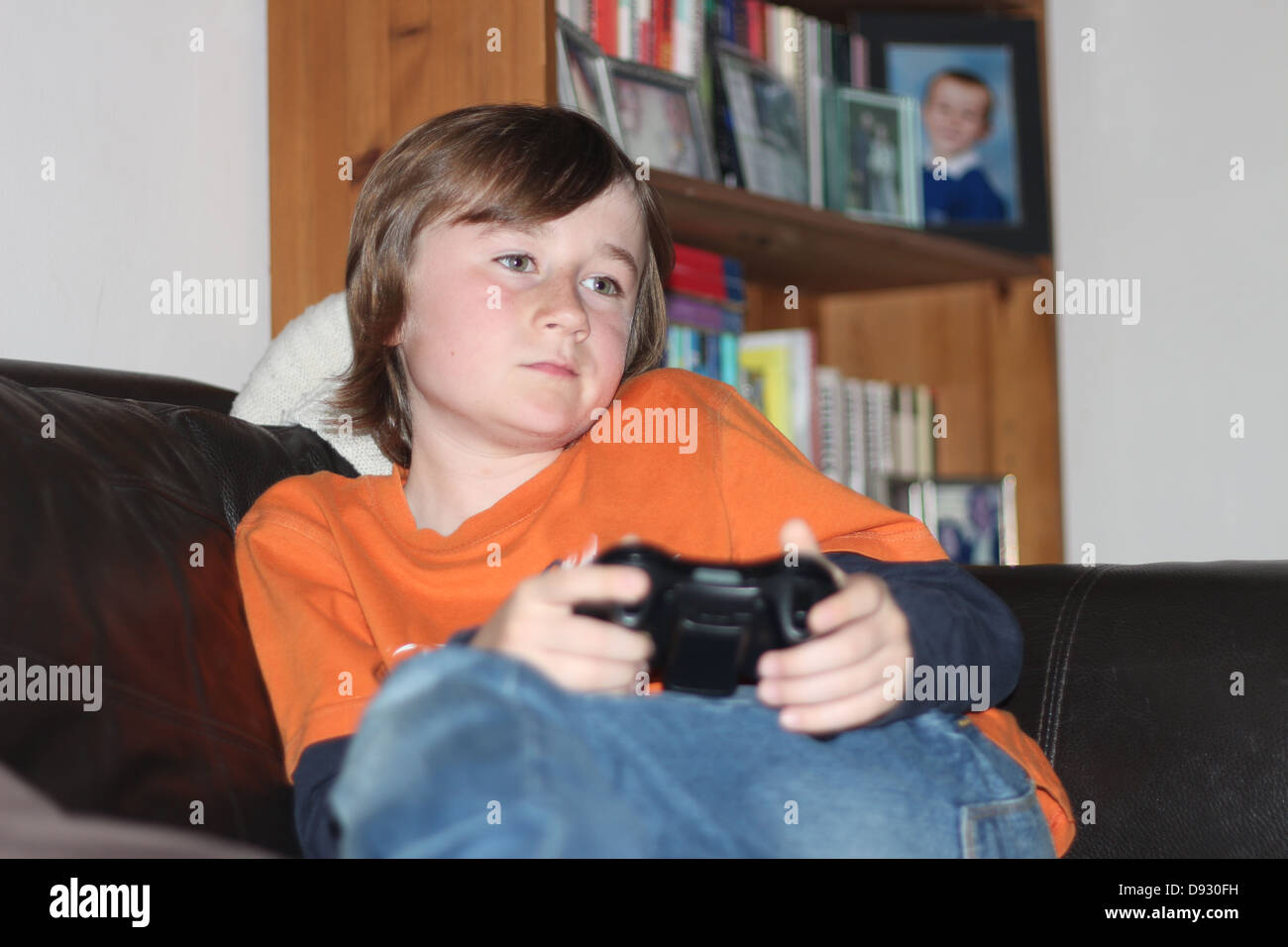 Bored boy gaming Stock Photo - Alamy
