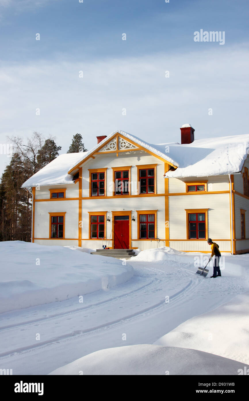 Woman removing snow from driveway Stock Photo - Alamy