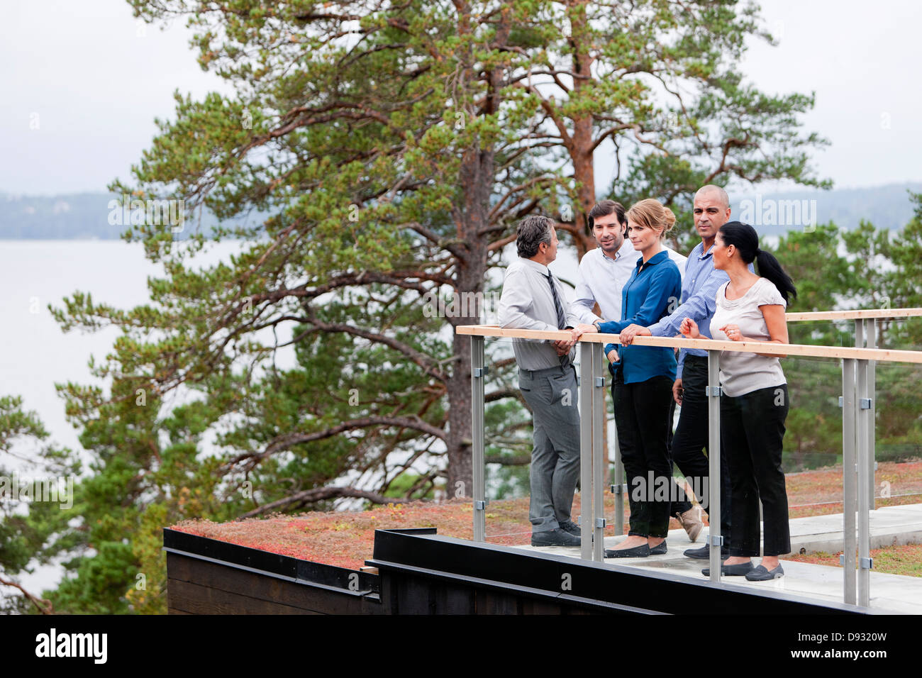 People talking on terrace Stock Photo - Alamy