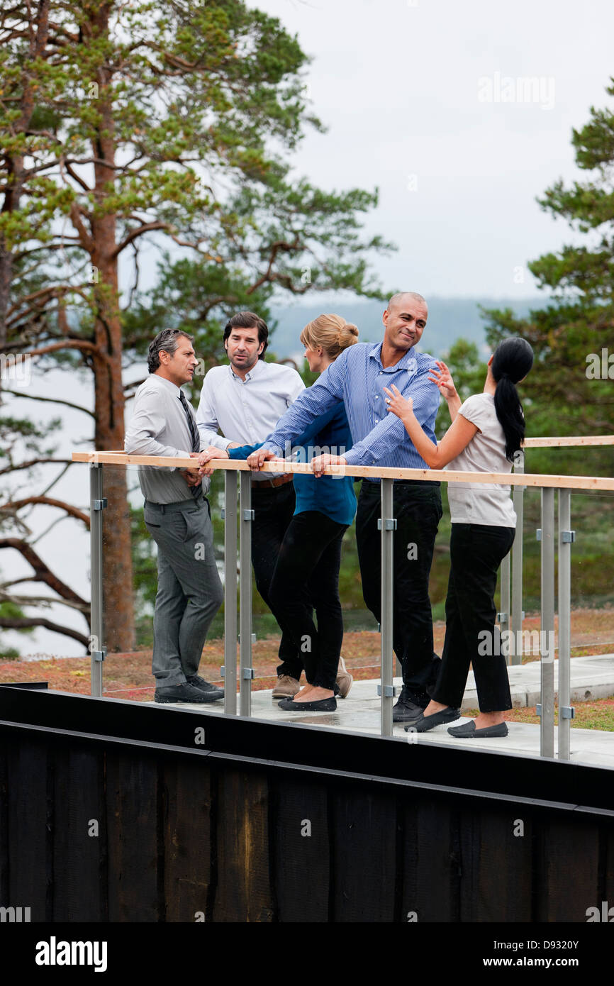 People talking on terrace Stock Photo - Alamy