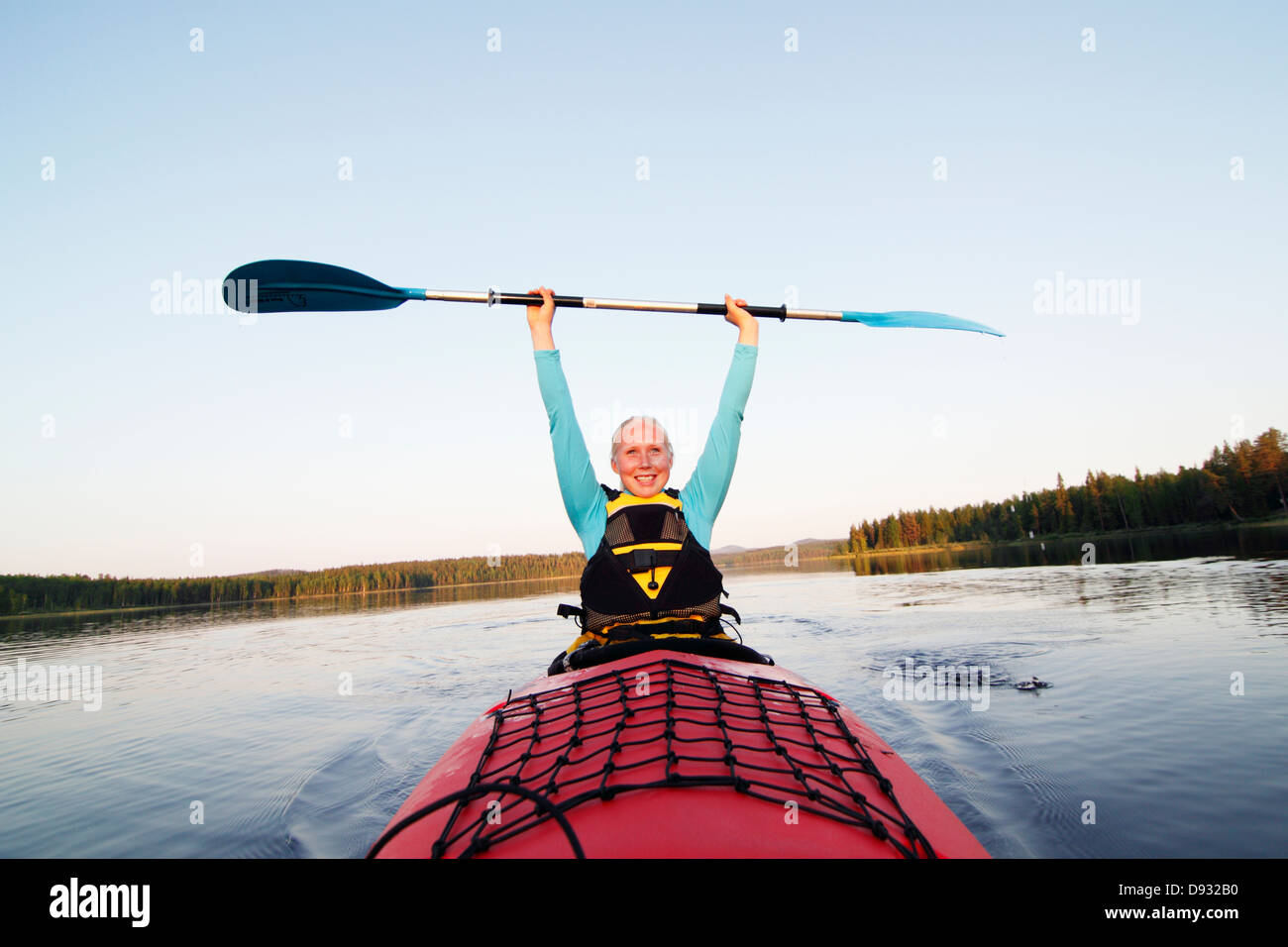 Smiling woman holding paddle hi-res stock photography and images - Alamy